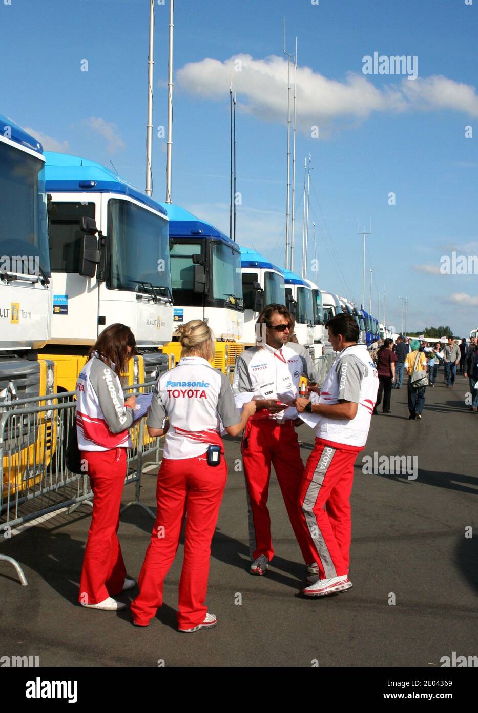 Members of the Toyota Formula 1 team talking at the rear of the pit ...