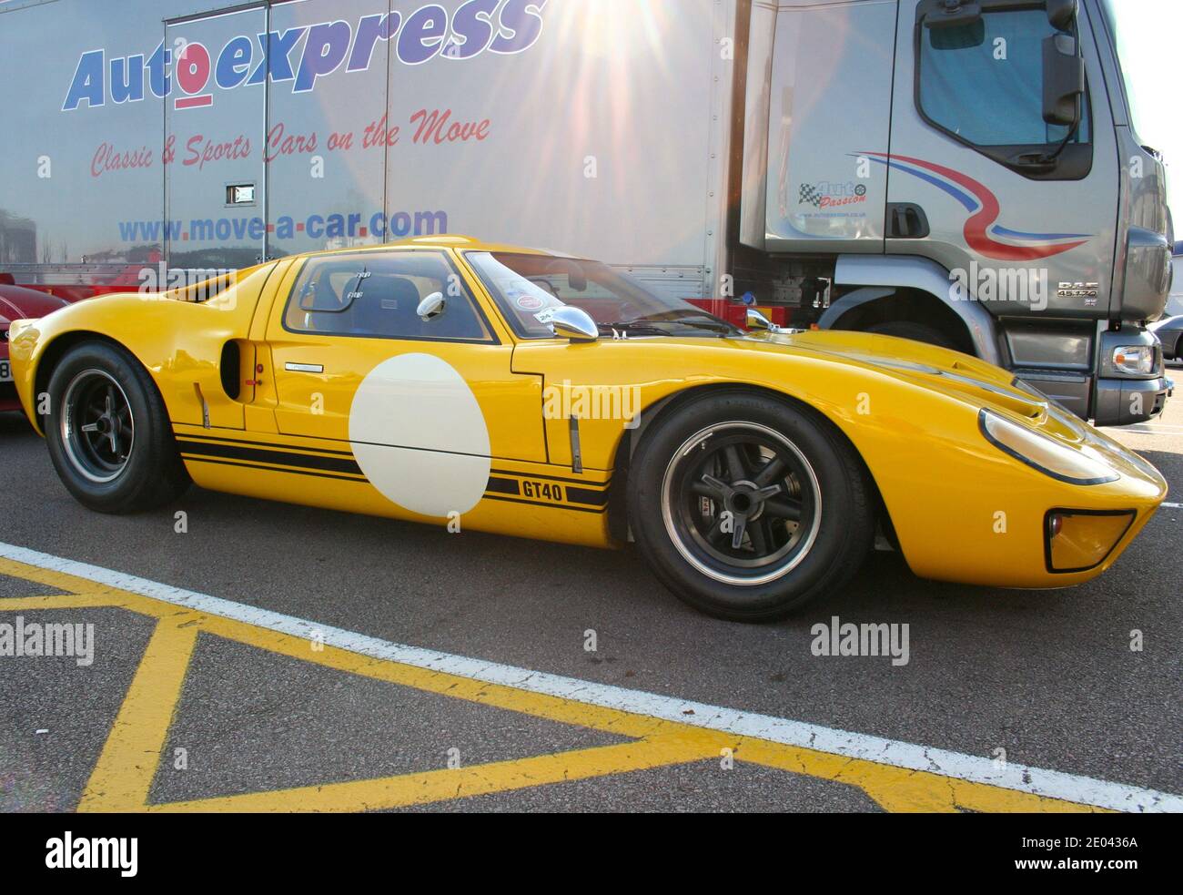 Yellow Ford GT40 parked in front of a lorry at Silverstone Race circuit England UK 20 September ...