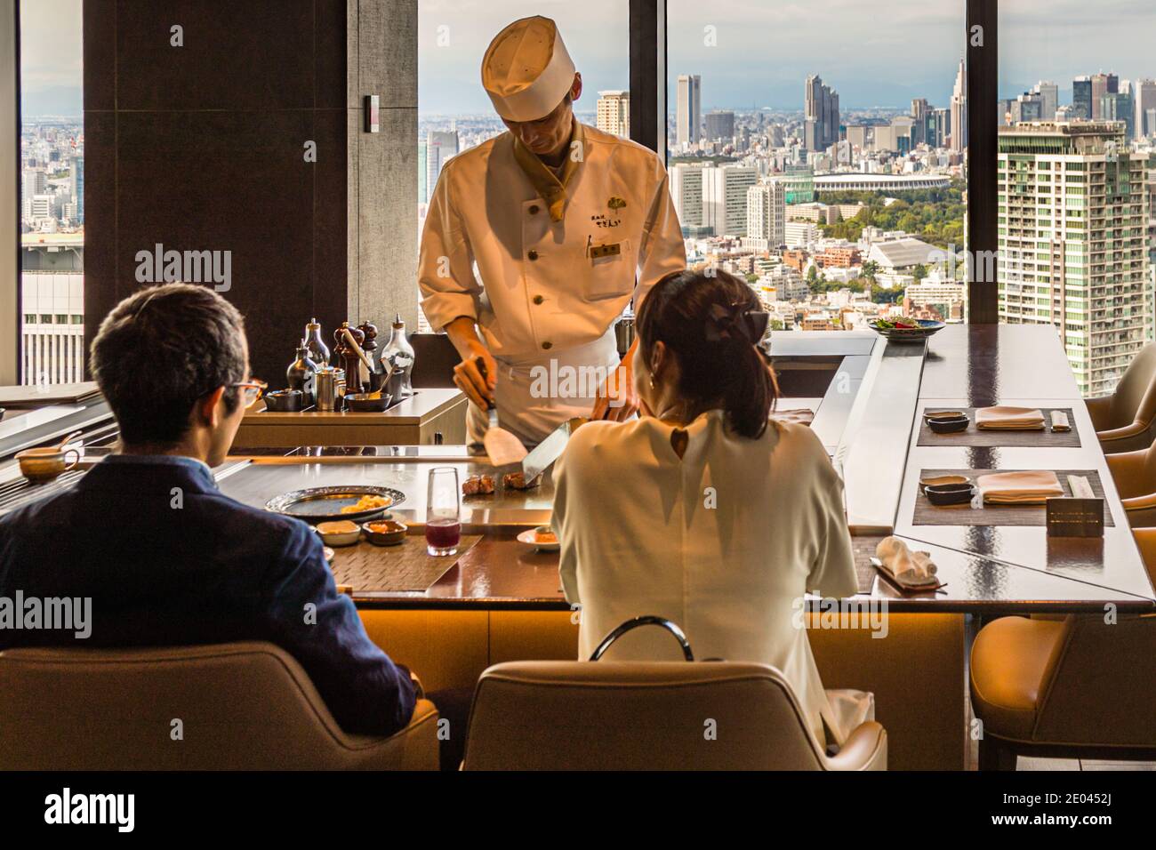 Teppanyaki restaurant in the Hotel Okura high above the roofs of Tokyo, Minato, Japan. Right ...