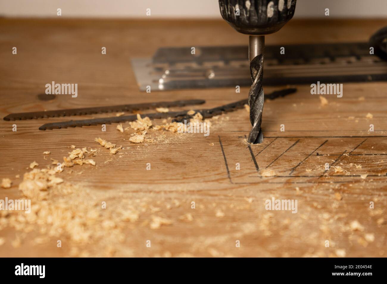 Wood processing. Drilling a hole in a wooden board using pencil ...