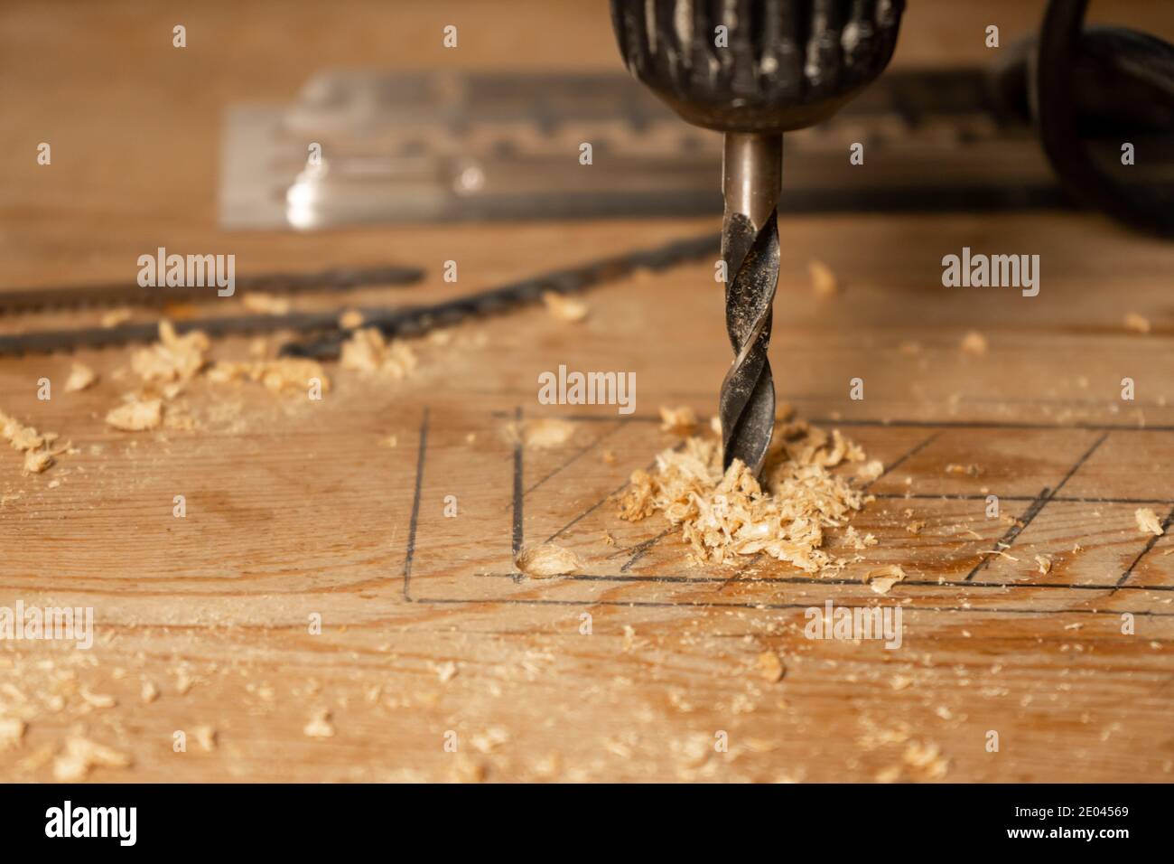Wood processing. Drilling a hole in a wooden board using pencil ...