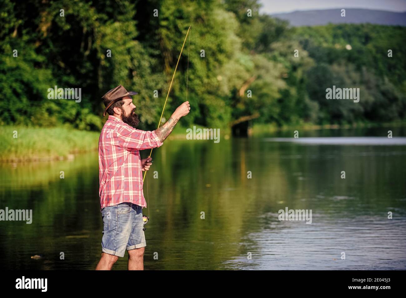 What a fish. mature bearded man with fish on rod. big game fishing ...