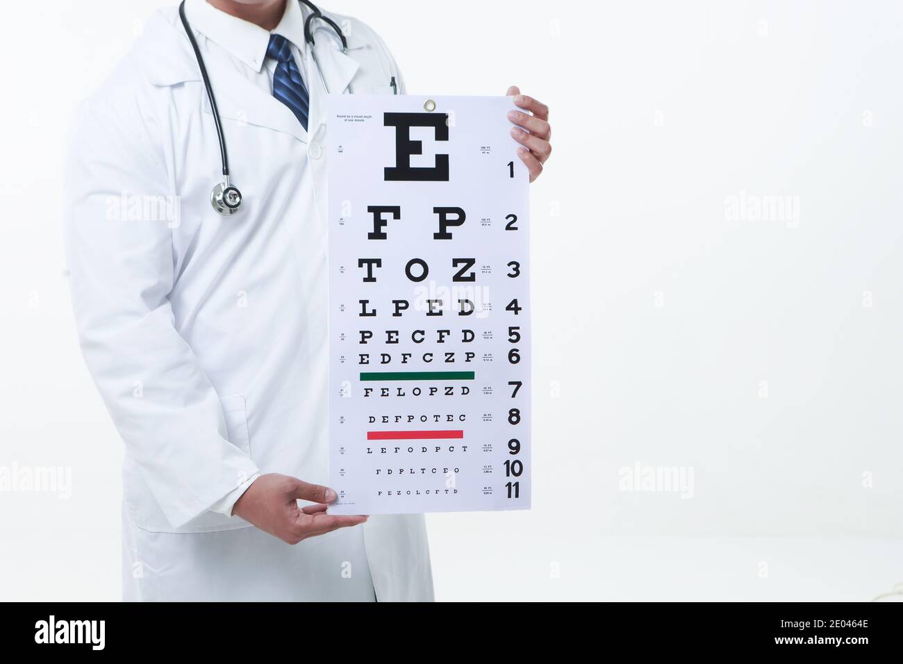Optometrist holding a vision chart to test a patients vision Stock ...