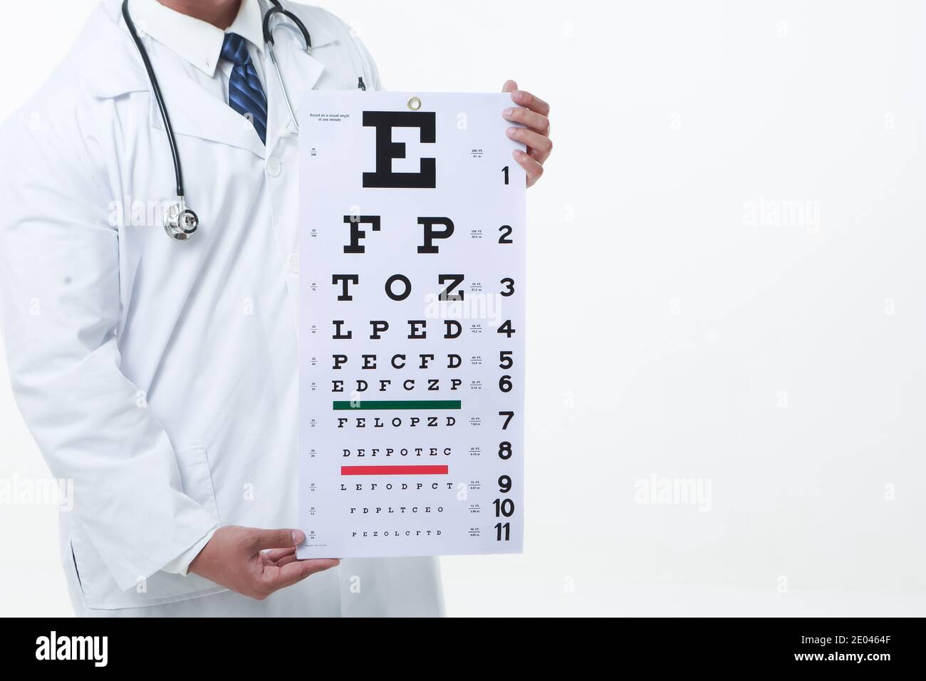 Optometrist holding a vision chart to test a patients vision Stock ...