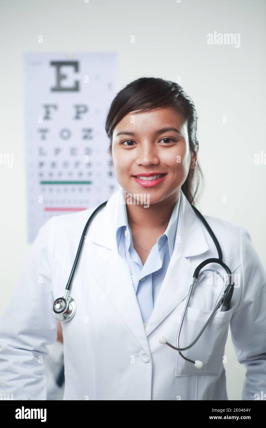 A female doctor with stethoscope and a vision chart at the back Stock ...