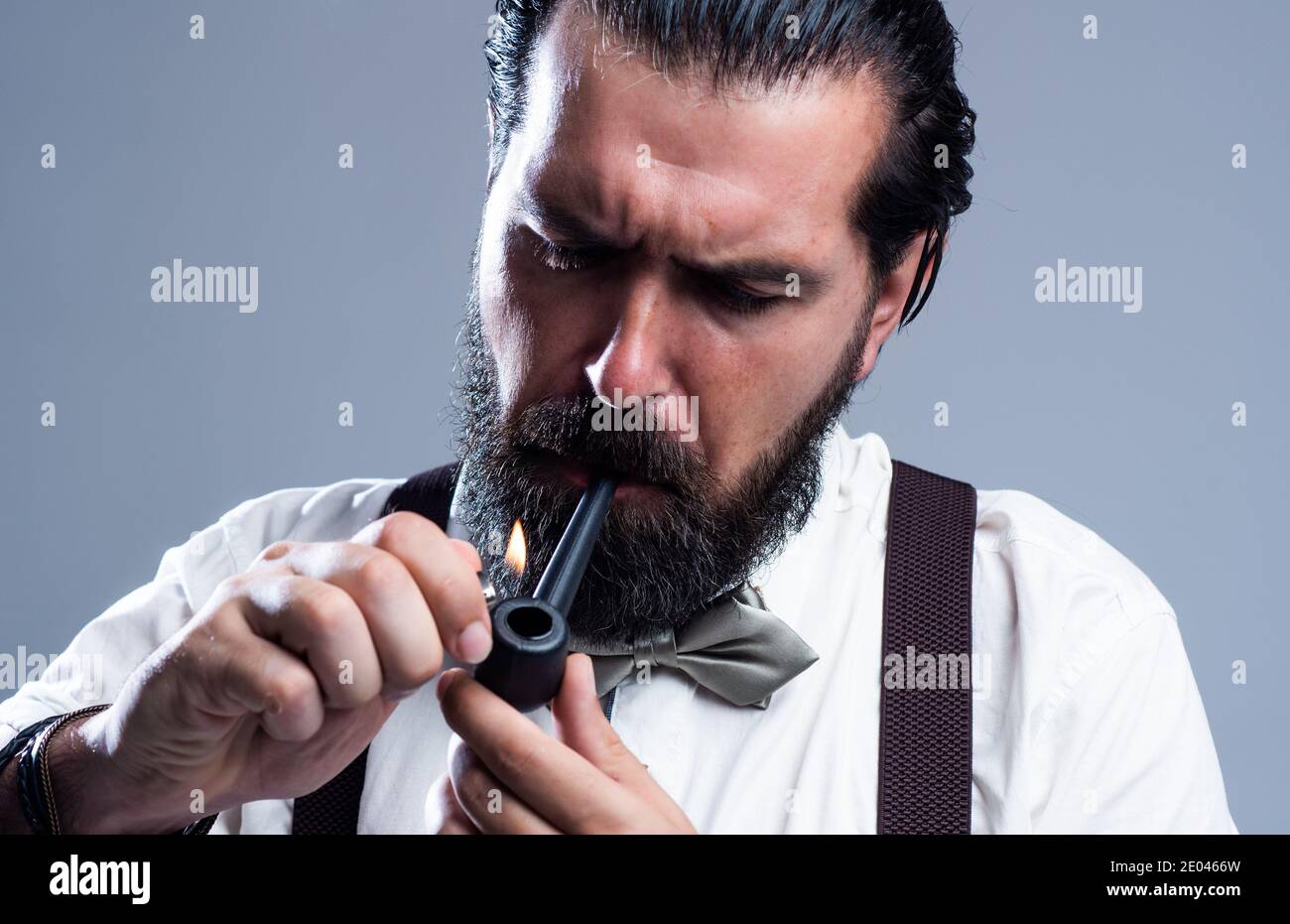 old fashioned bearded hipster smoke pipe. brutal handsome man with ...