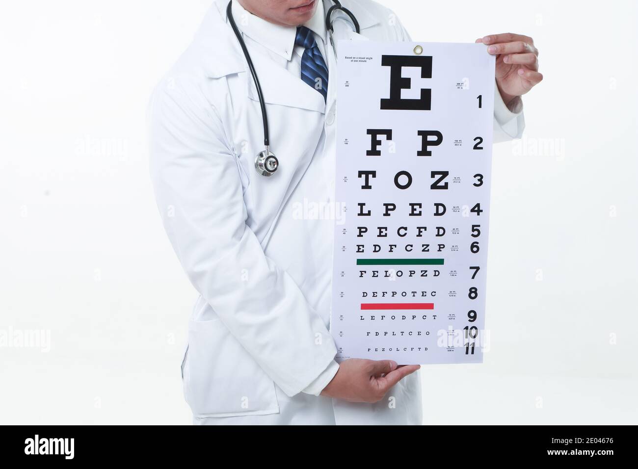 Optometrist holding a vision chart to test a patients vision Stock ...