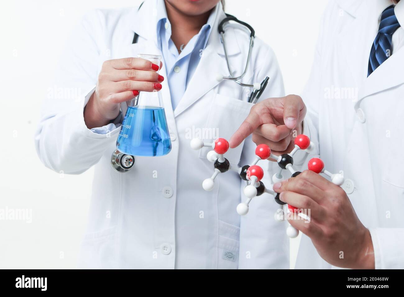 Doctor and chemist working together with chemicals and chemical matrix ...