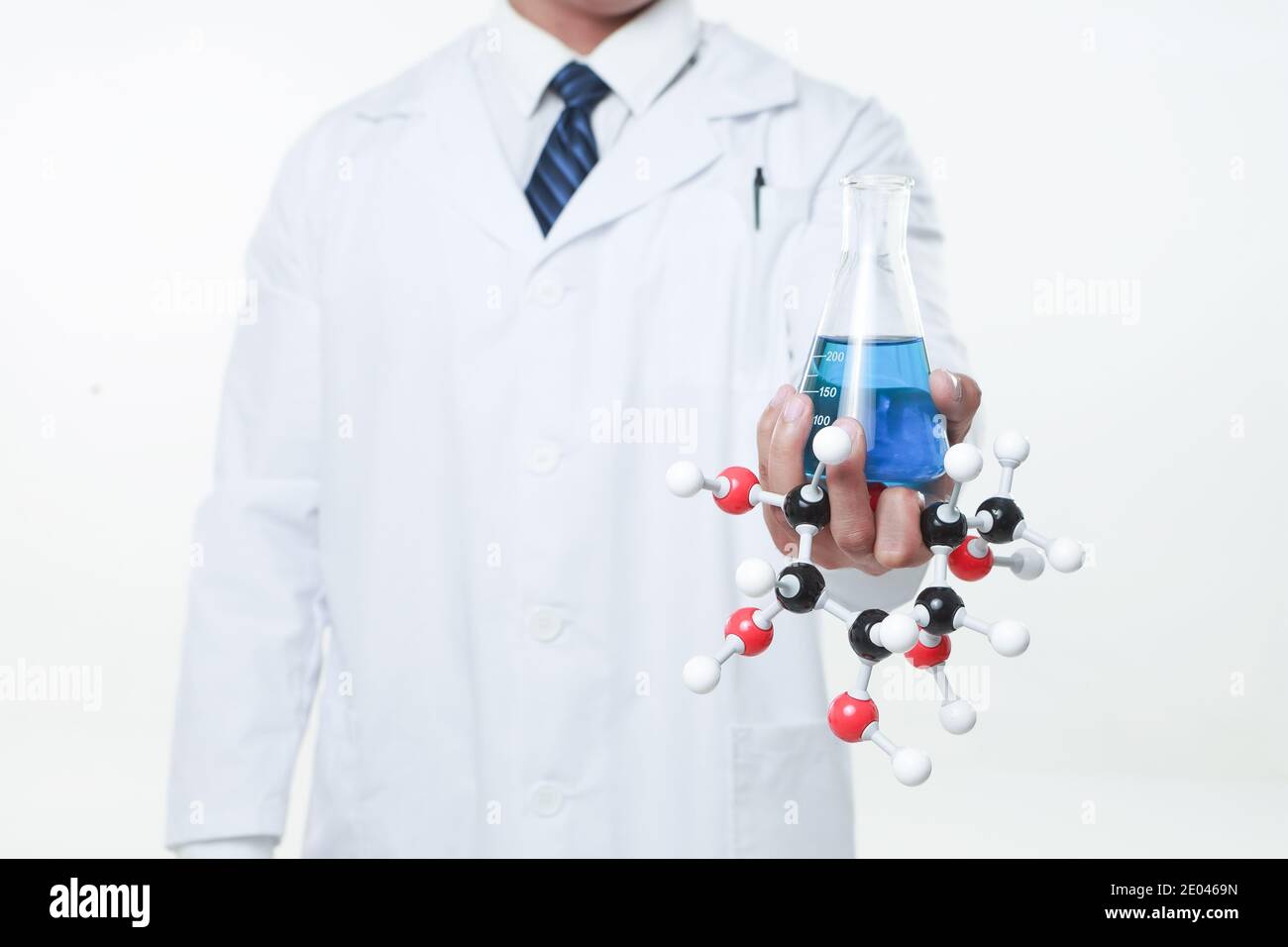A chemist holding a flask and chemical matrix Stock Photo - Alamy