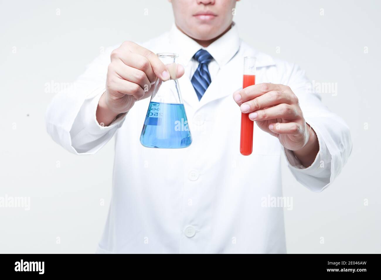 A chemist holding a flask and chemical matrix Stock Photo - Alamy
