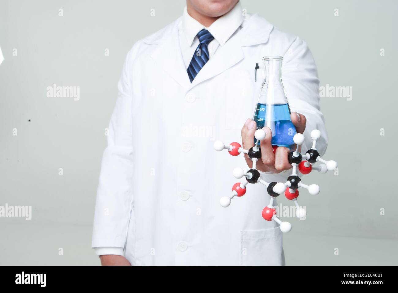 A chemist holding a flask and chemical matrix Stock Photo - Alamy