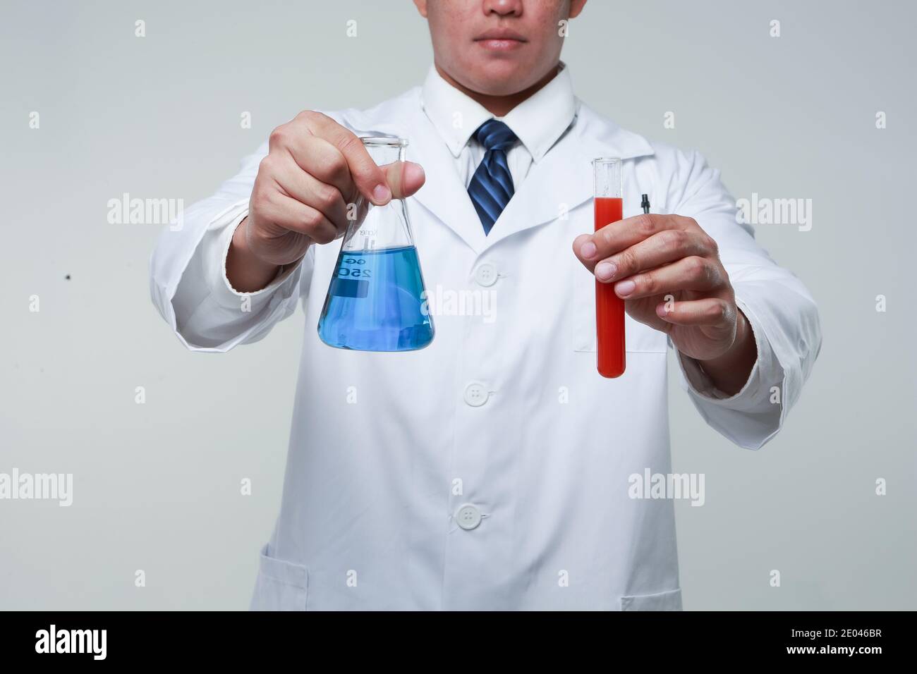 A chemist holding a flask and chemical matrix Stock Photo - Alamy