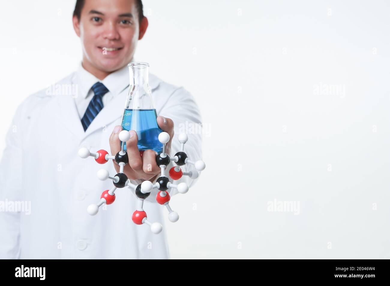 A chemist holding a flask and chemical matrix Stock Photo - Alamy