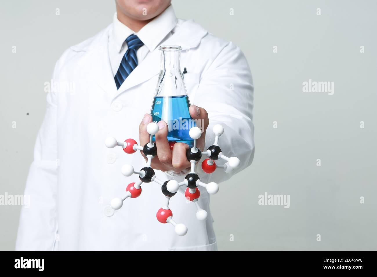 A chemist holding a flask and chemical matrix Stock Photo - Alamy
