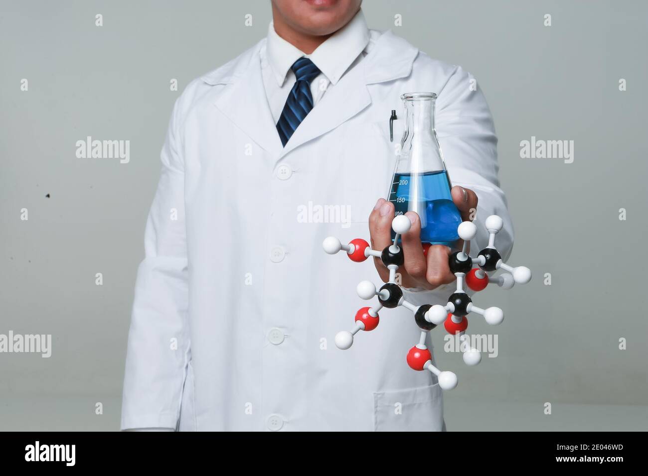 A chemist holding a flask and chemical matrix Stock Photo - Alamy
