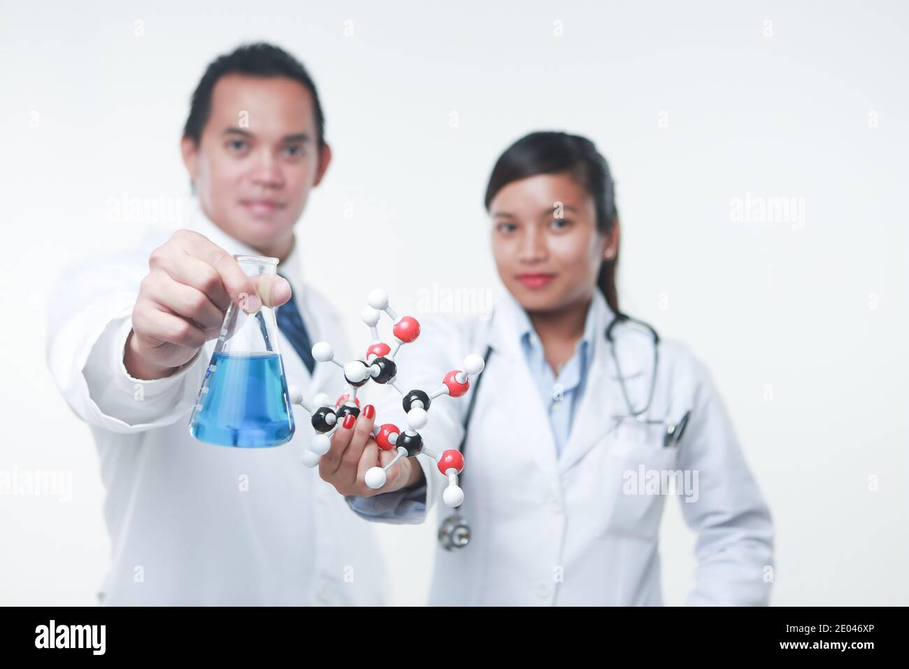 Doctor and chemist working together with chemicals and chemical matrix ...