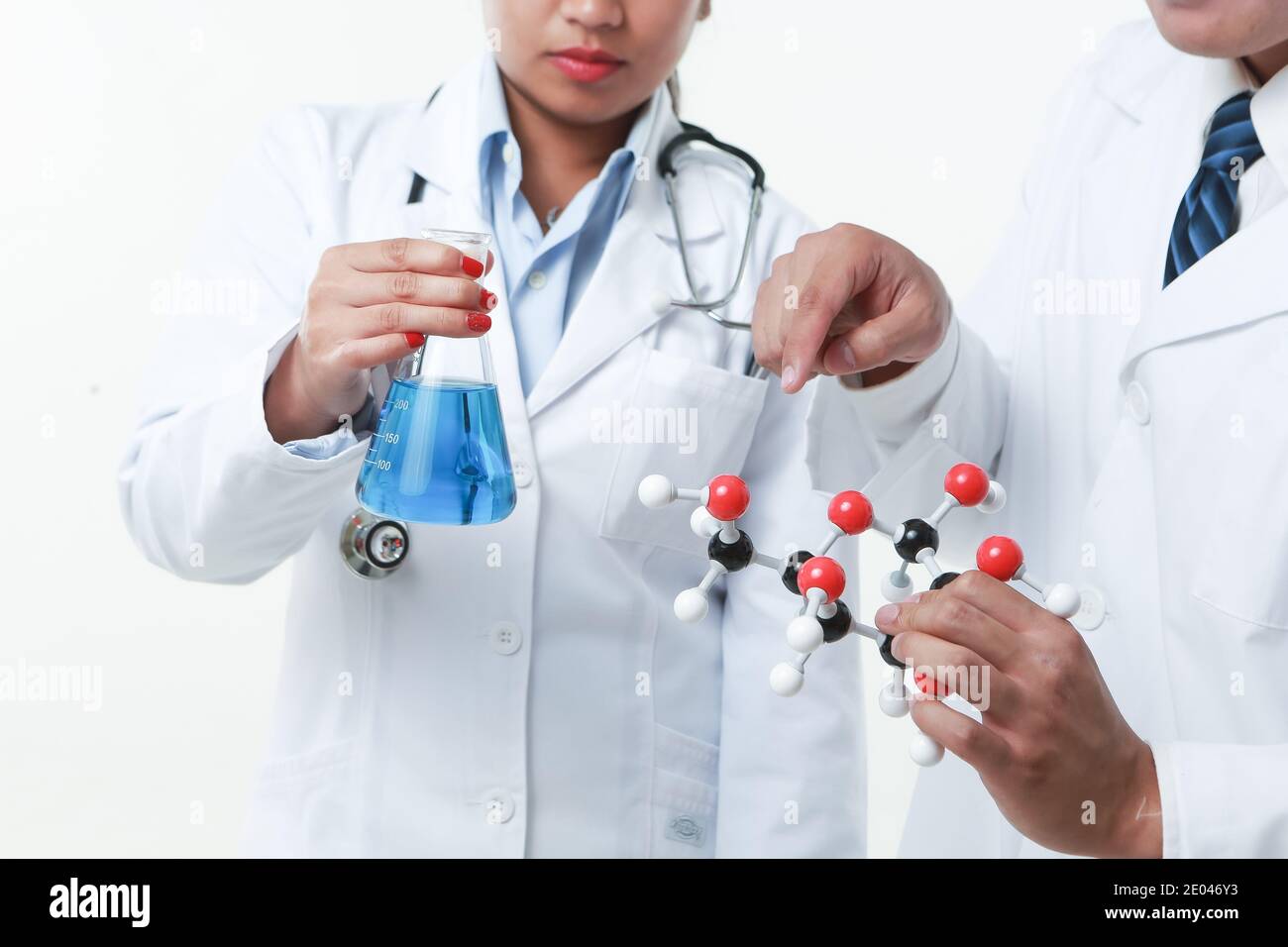 Doctor and chemist working together with chemicals and chemical matrix ...
