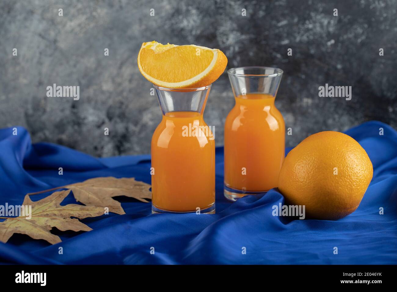 Two glass pitchers with delicious juice and sliced orange fruit Stock Photo - Alamy