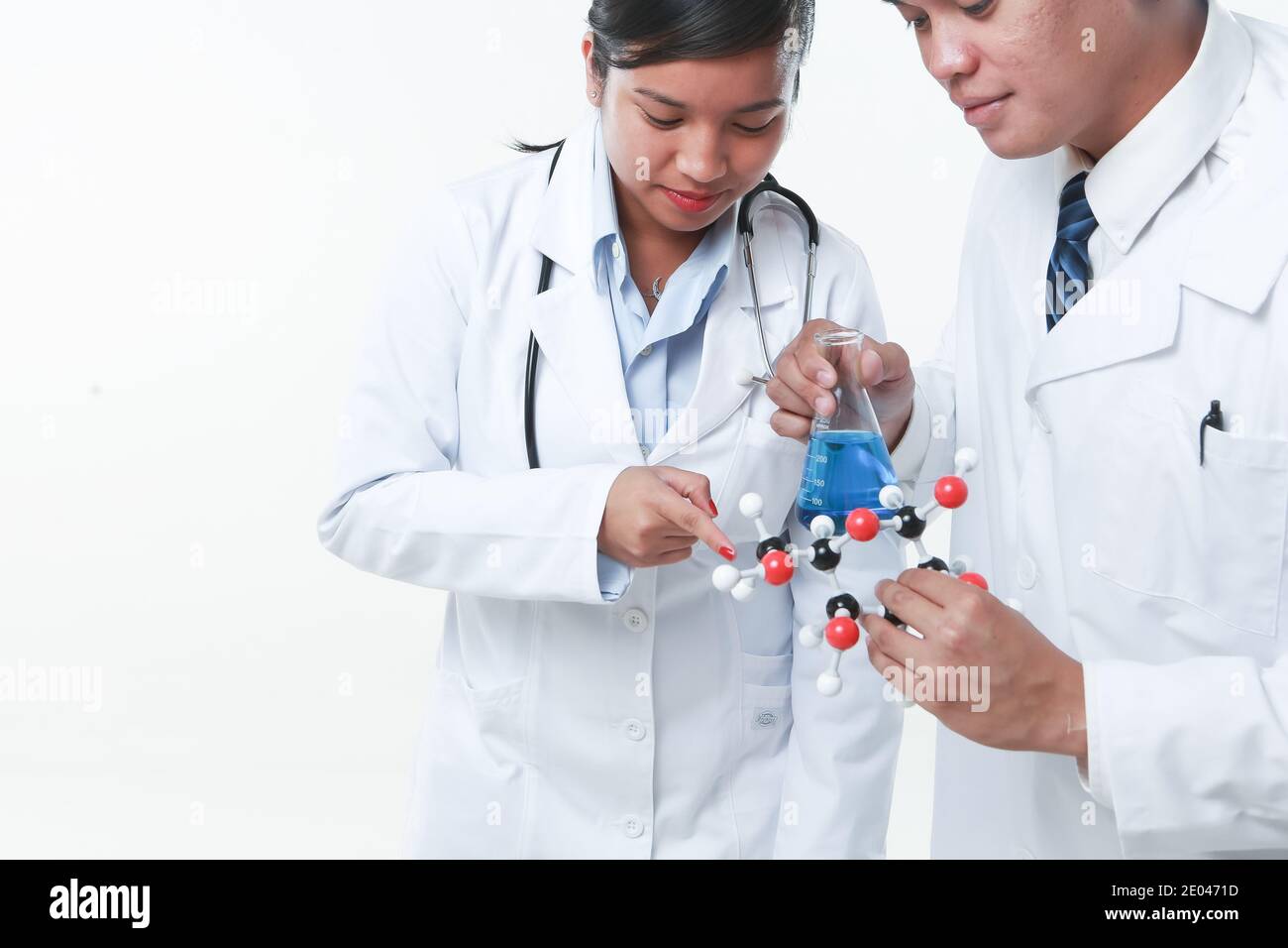 Doctor and chemist working together with chemicals and chemical matrix ...