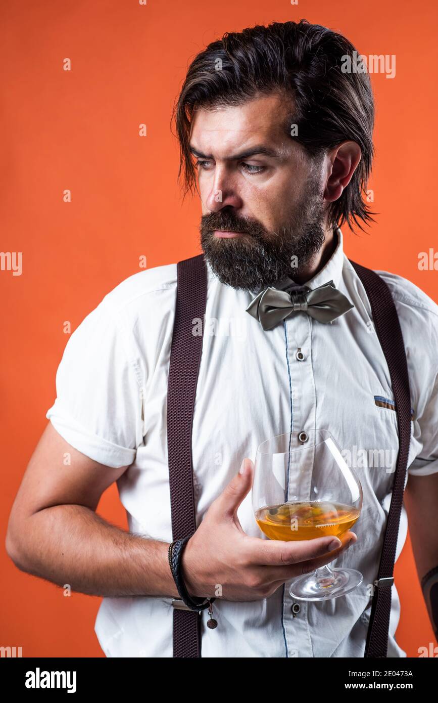 brutal bearded male with stylish look drinking brandy, bartender Stock ...