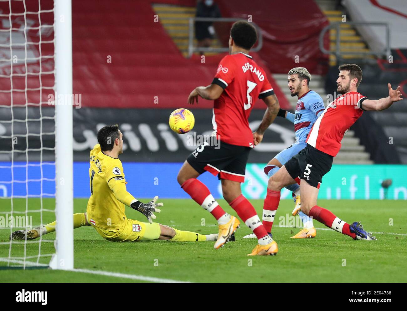 Southampton goalkeeper Alex McCarthy (left) makes a save from West Ham ...