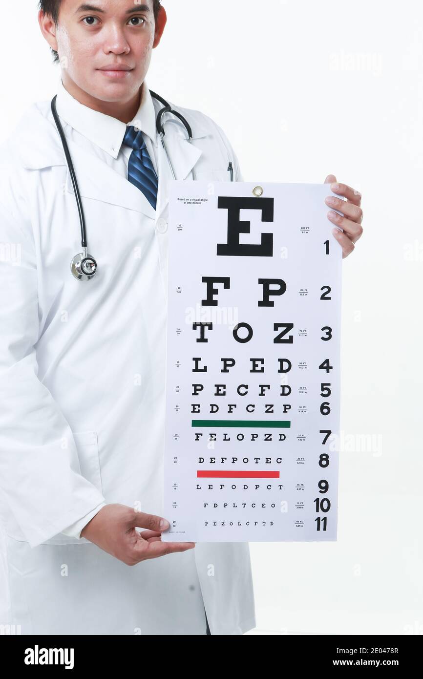 Optometrist holding a vision chart to test a patients vision Stock ...