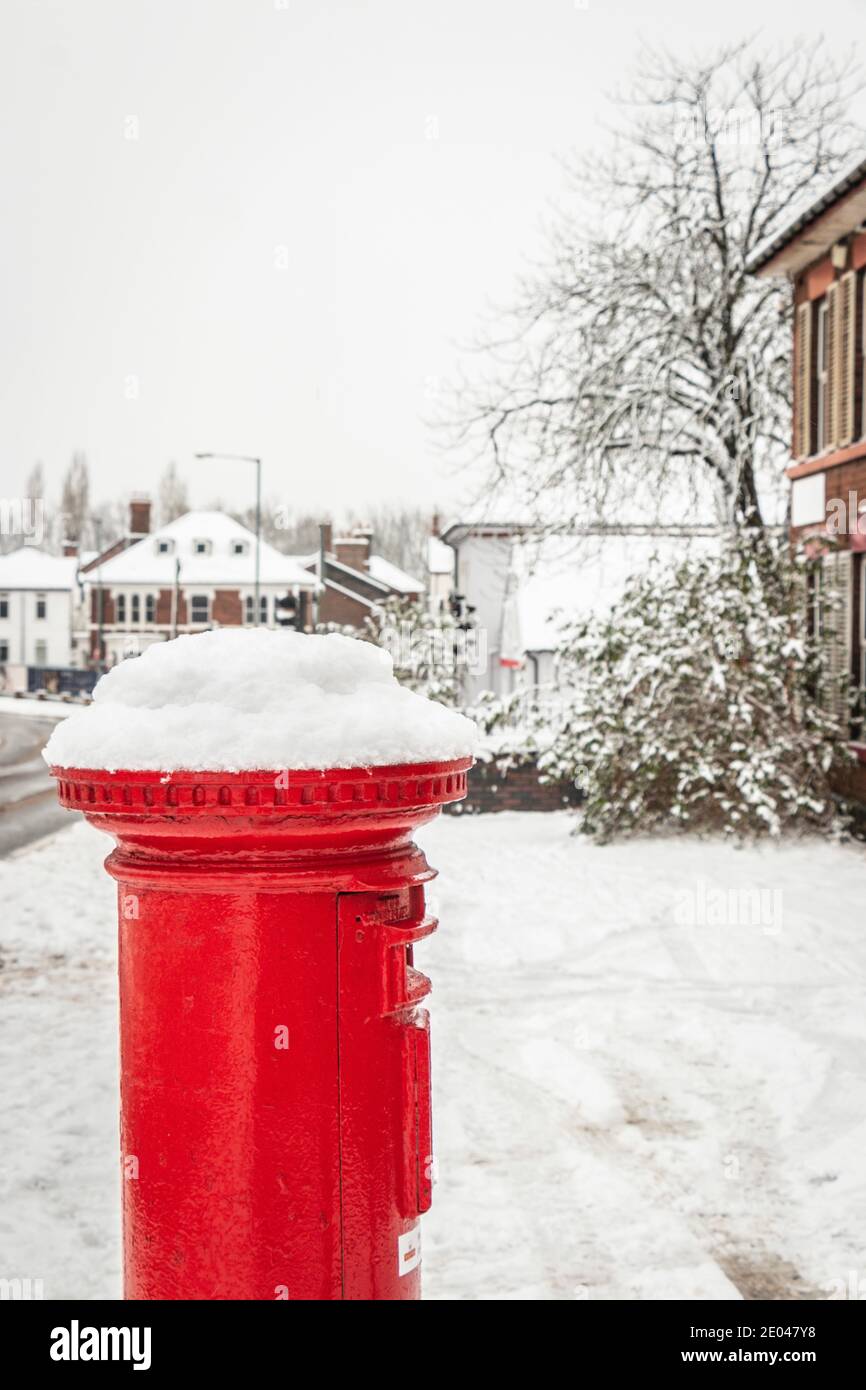 red Royal Mail UK post box in snowy street scene Stock Photo - Alamy
