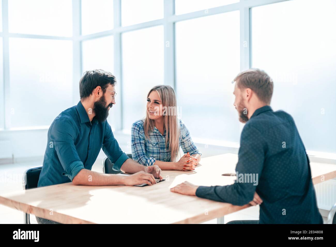 managers discussing the results of an interview with a young employee ...