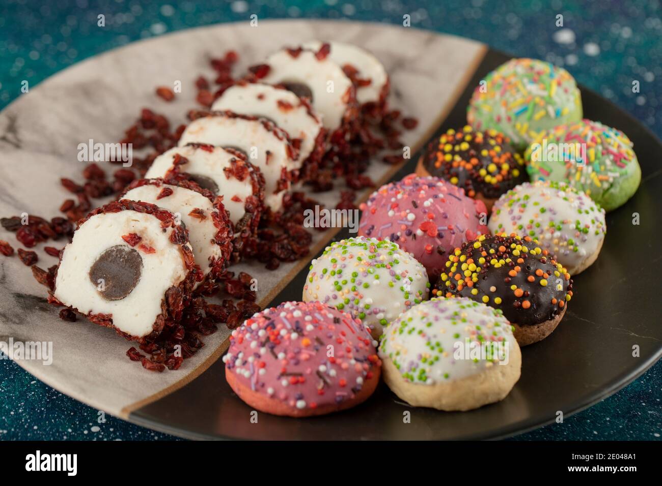 Colorful set of sweet small doughnuts on a plate Stock Photo - Alamy