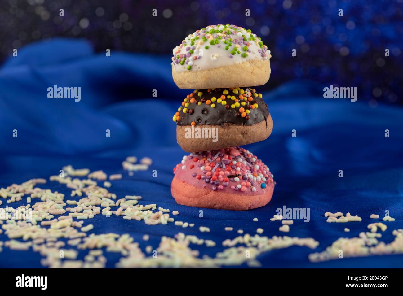Colorful set of sweet small doughnuts on a blue background Stock Photo ...