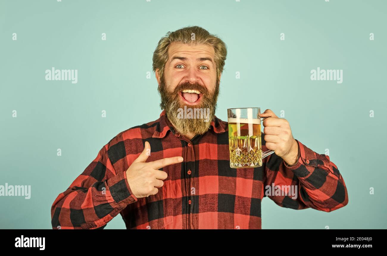 Beer with foam. Hipster drink beer. Mature bearded guy hold beer glass ...