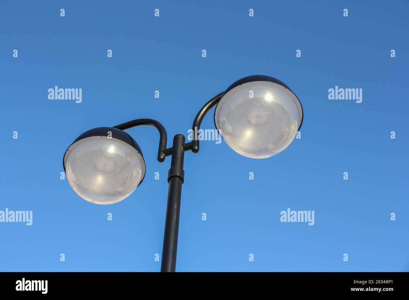treet lamp made of two balls against the blue sky. Street lighting ...