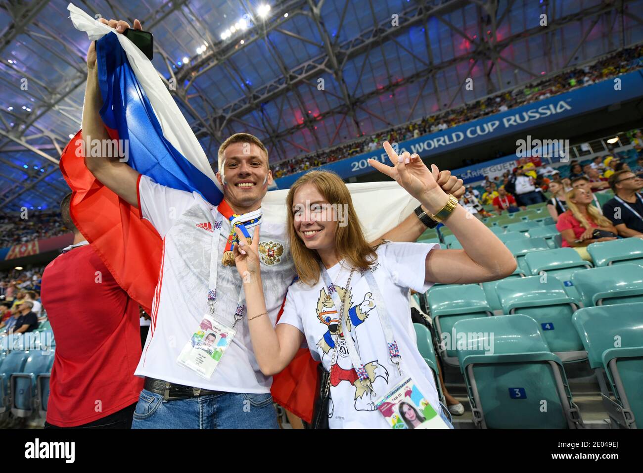 SOCHI, RUSSIA-23 JUNE 2018 A fan couple cheers from tribune holding the ...