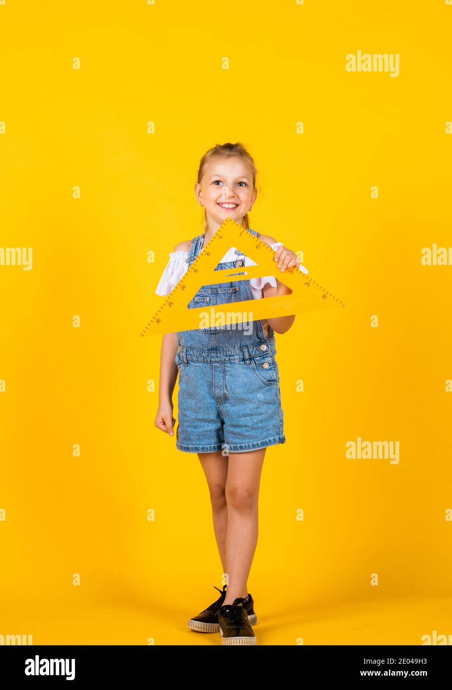 cute kid use triangle ruler tool, geometry Stock Photo - Alamy