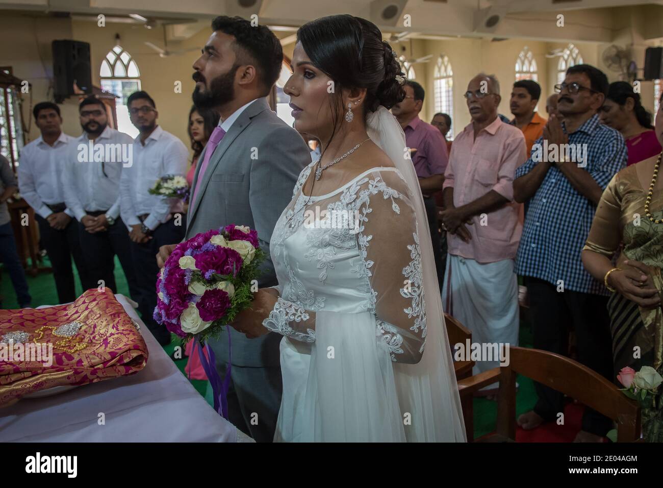 Kerala, India, 08-12-2017. Bride and groom closer to the altar ...