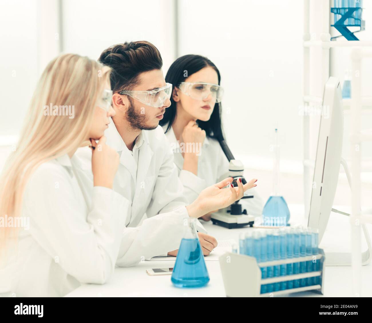 team of scientists discussing something at the Desk Stock Photo - Alamy