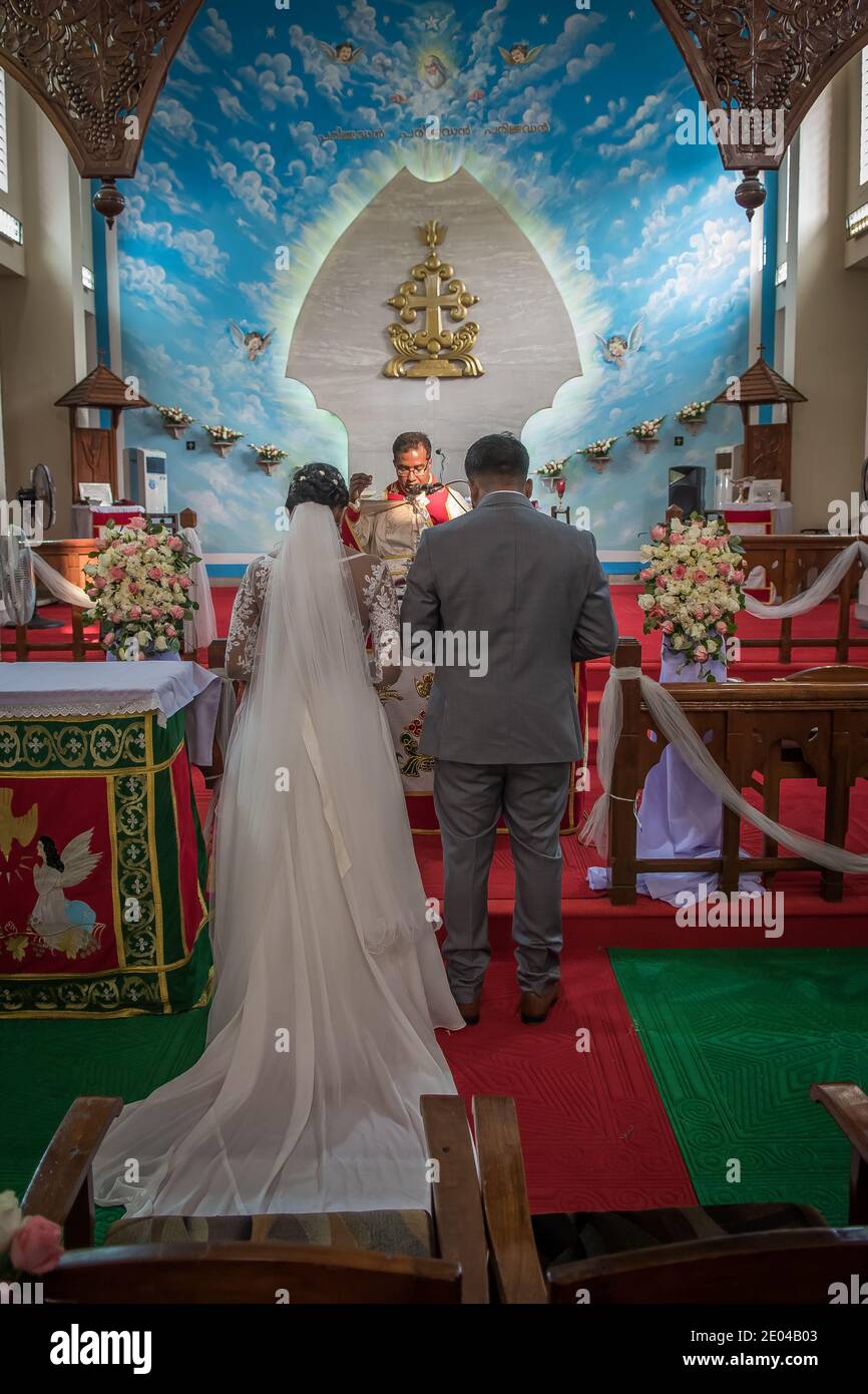 Kerala, India, 08-12-2017. Bride and groom closer to the altar ...