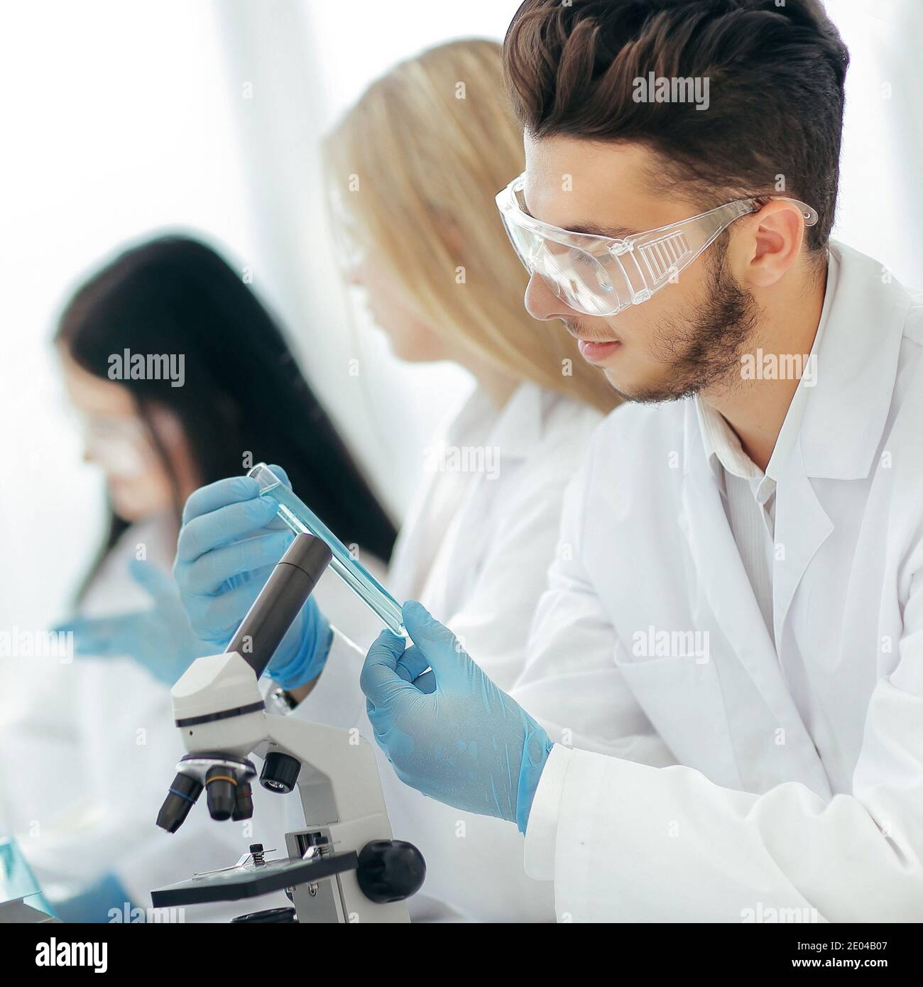 group of young biologists sitting at the laboratory table Stock Photo ...
