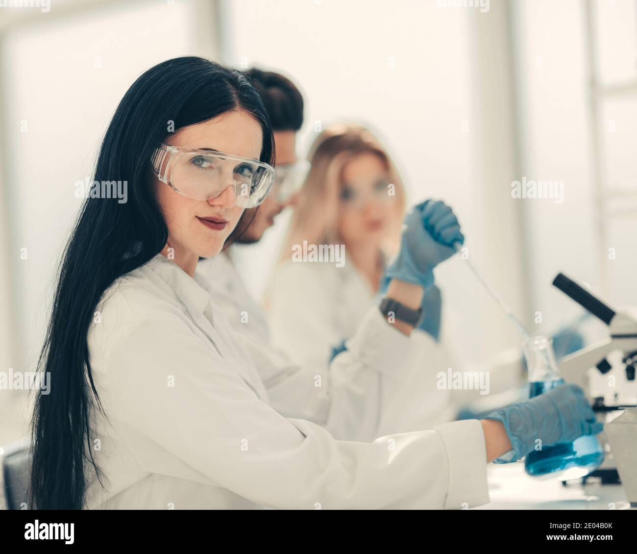 close up.modern woman sitting with colleagues at the laboratory Stock ...