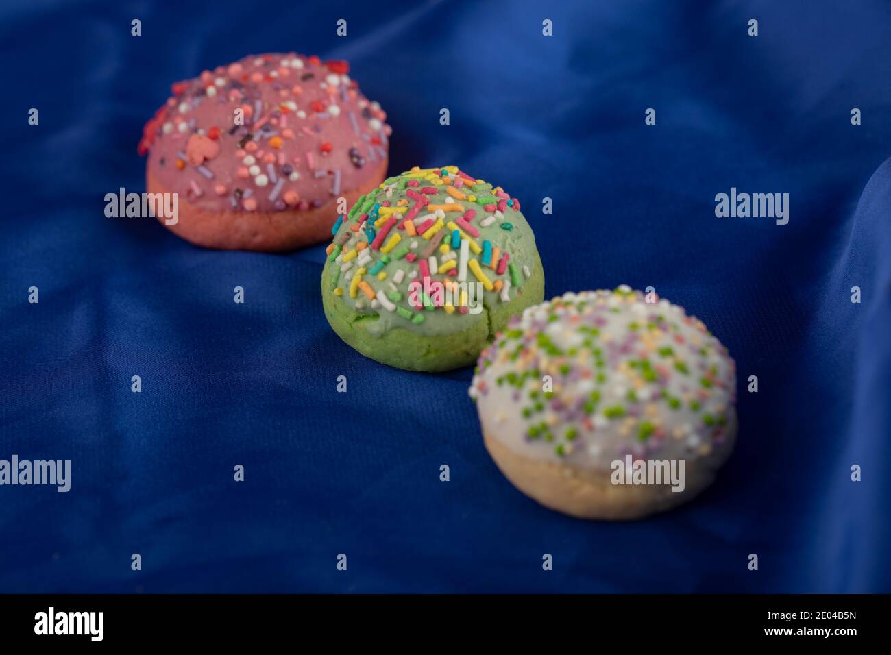 Colorful set of sweet small doughnuts on a blue background Stock Photo ...