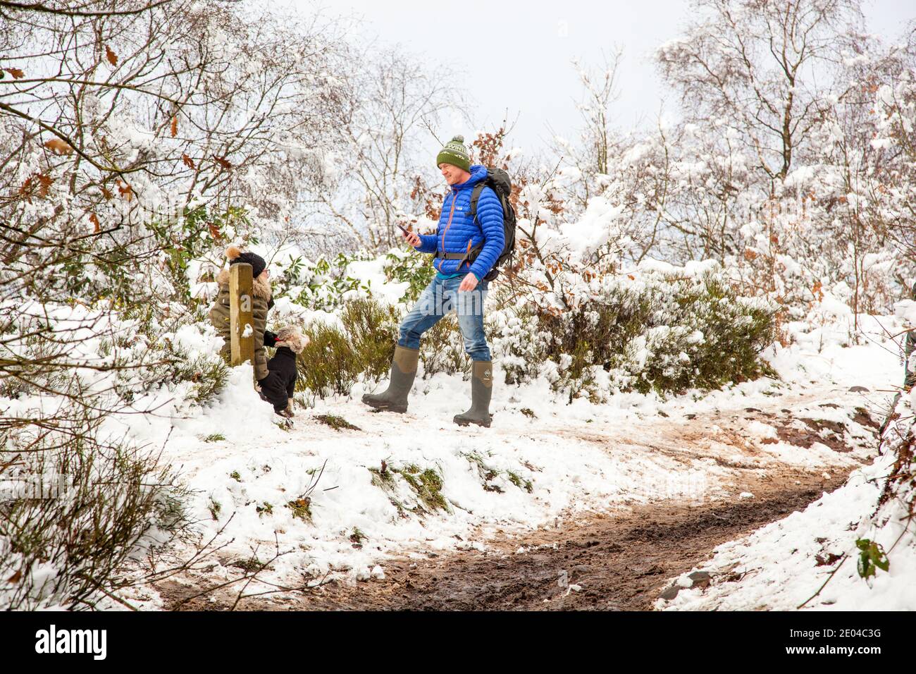 Man and woman stopped for a rest while walking along a path in snow ...