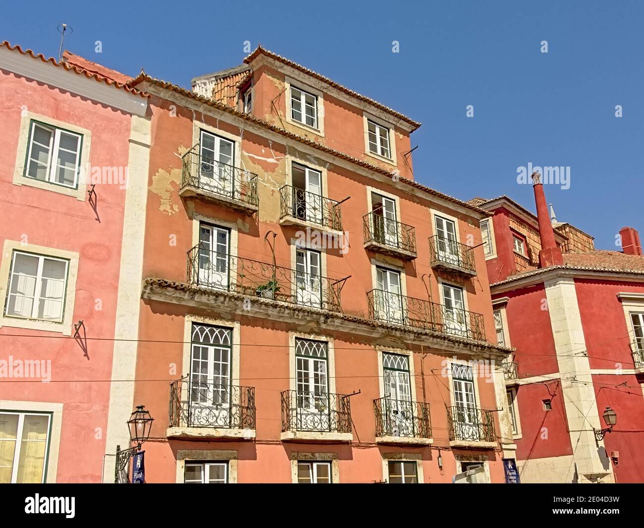 Facade of a typical apartment building in pastel colors in Lisbon ...