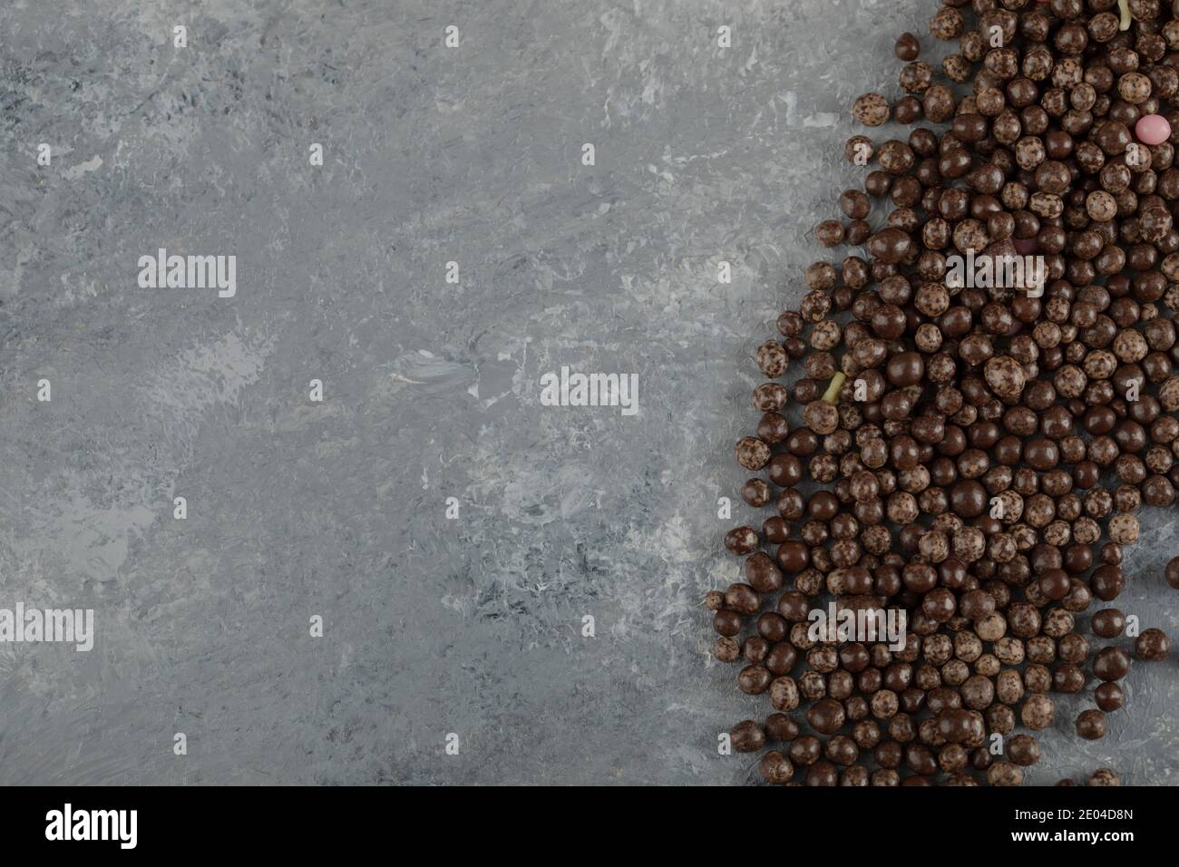 Chocolate sprinkles on a stone background Stock Photo - Alamy