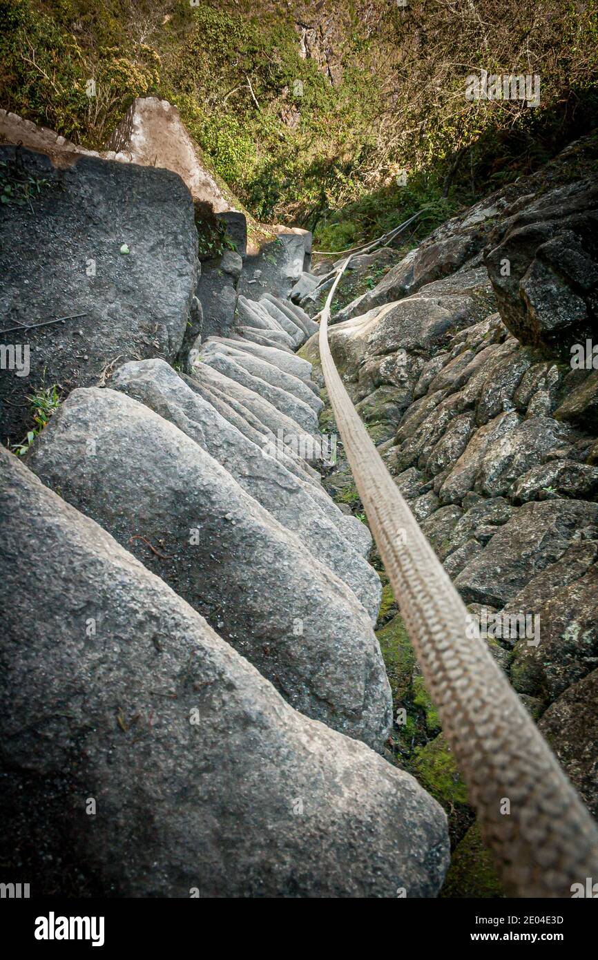 Looking down a very steep set of stairs with a rope Stock Photo - Alamy