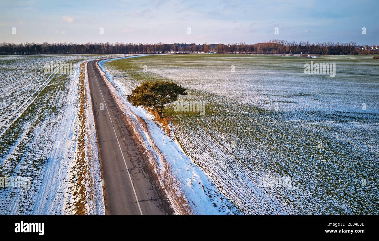 Winter Agricultural field under snow. Countryside road Aerial view ...