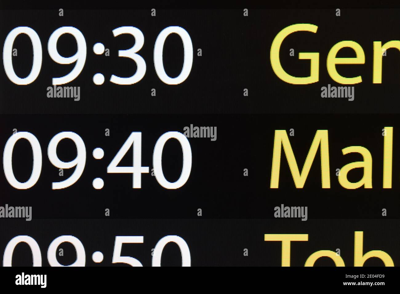 Detail of airport departure board showing flight schedules and ...