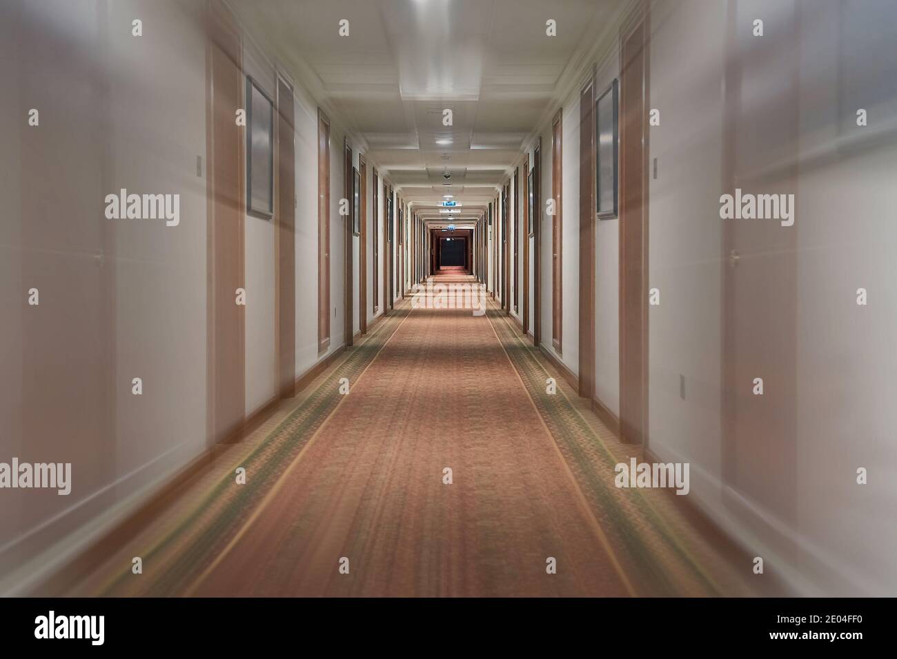 Corridor with with long line of doors Stock Photo - Alamy