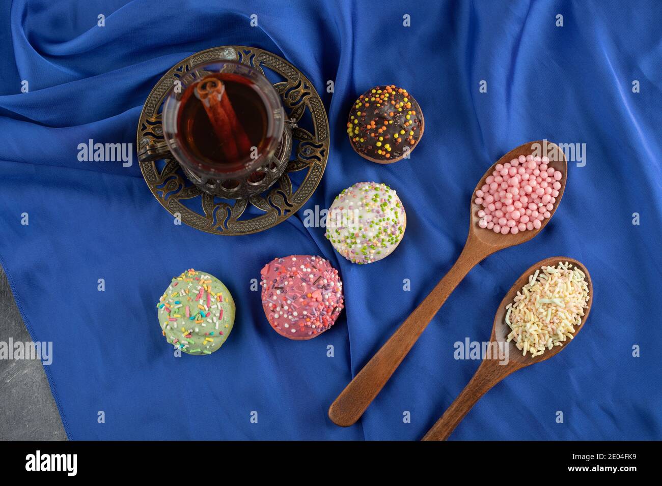 Wooden spoons full of colorful sprinkles with a cup of tea Stock Photo ...