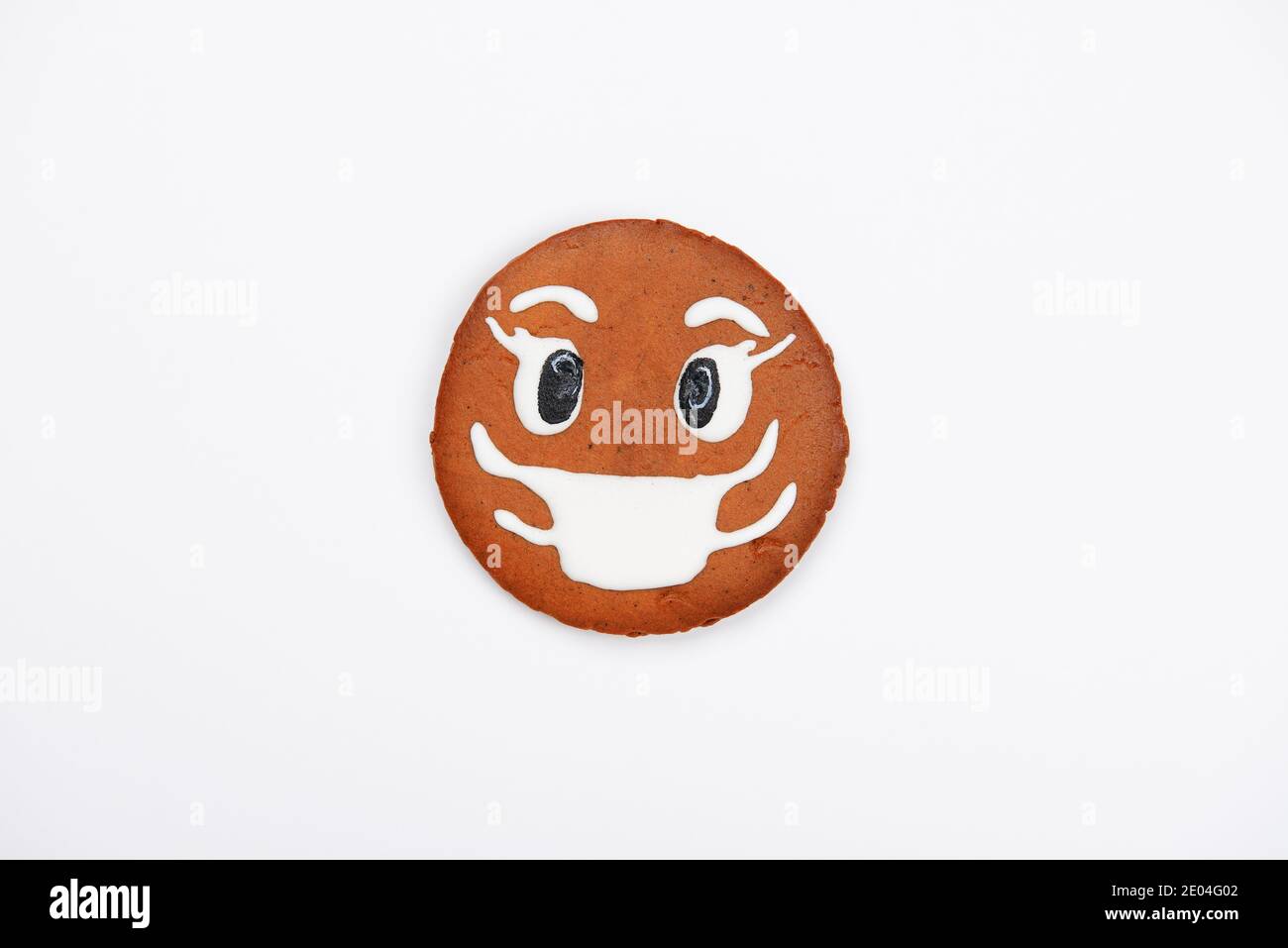 The hand-made eatable gingerbread Earth with face mask concept on white ...