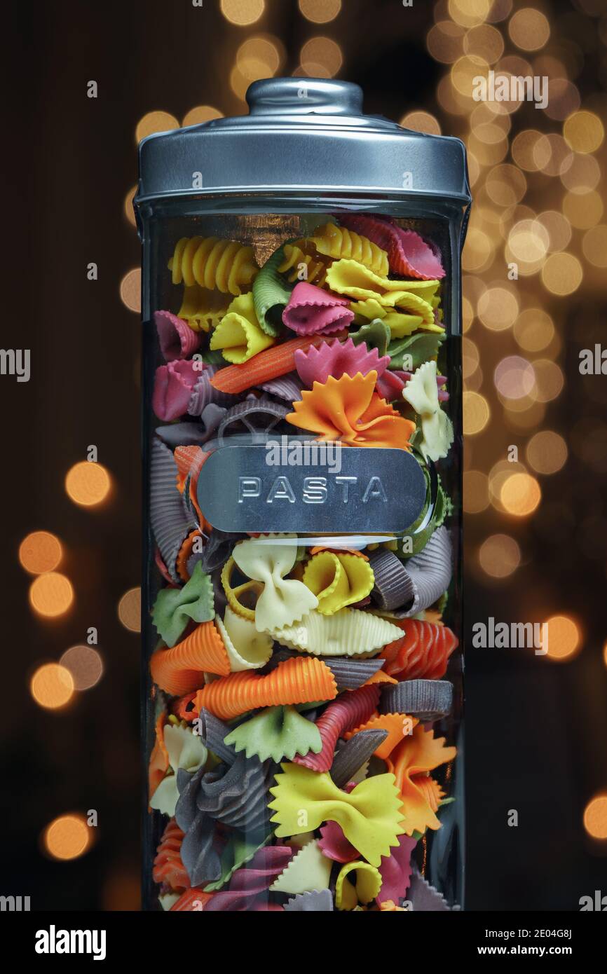 Different colored pasta in a glass, closeup, In the background a ...